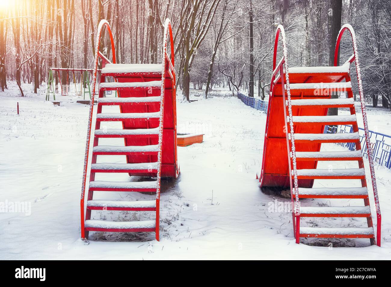 Empty children playground in winter day. Sunset time Stock Photo - Alamy