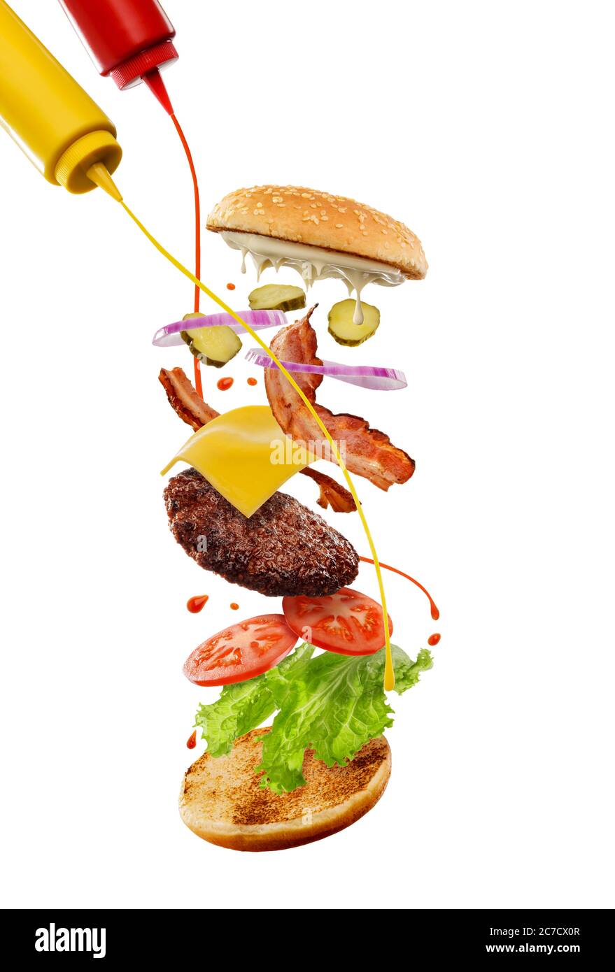 Cooking a cheeseburger. Layers of snack, creative concept Stock Photo ...