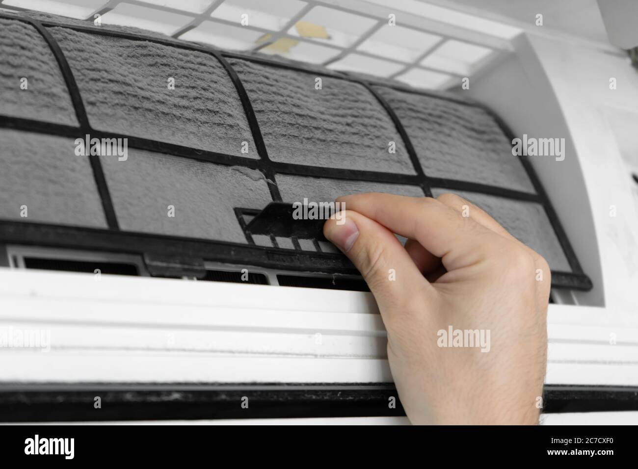 The guy cleans the filter of the home air conditioner from dust. Very ...