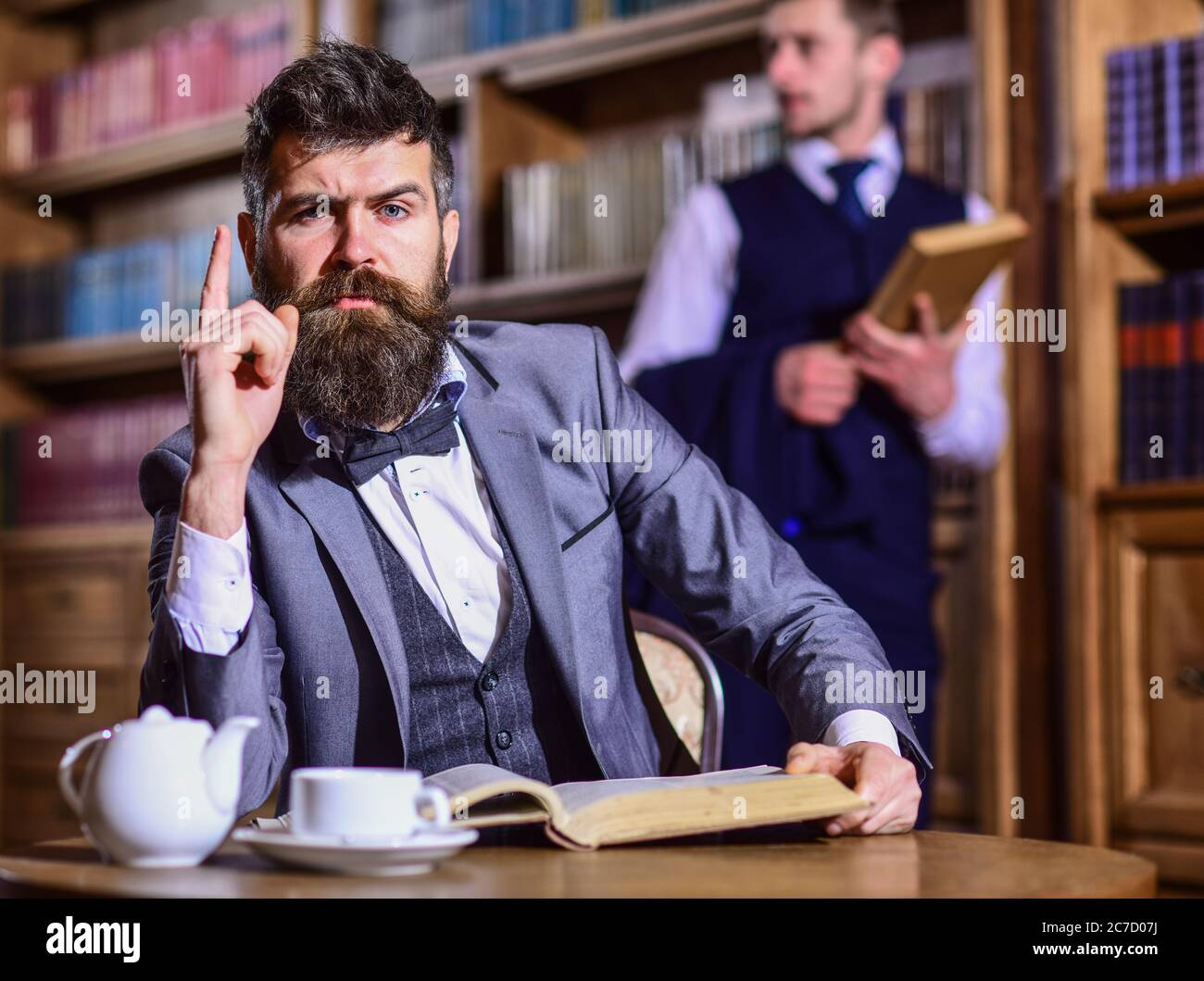 Men in suit, detectives spend leisure in library. Private investigator ...
