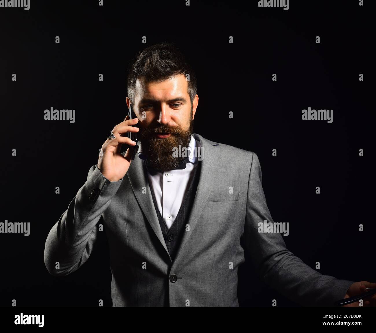 Technology and communication concept. Macho in formal suit has phone ...