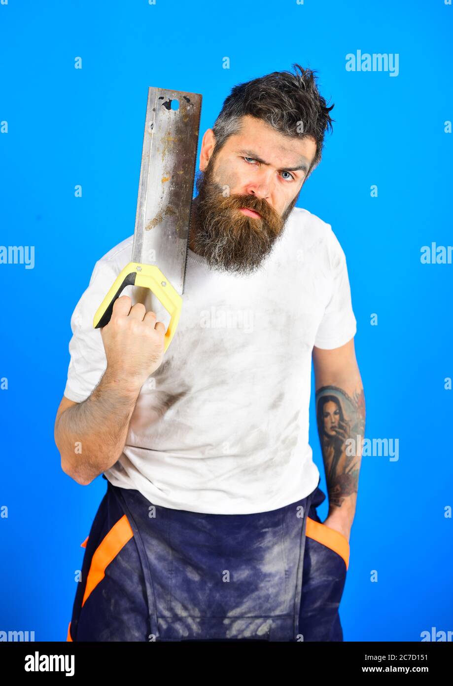 Brutal carpenter concept. Builder, worker, carpenter, handyman holds ...