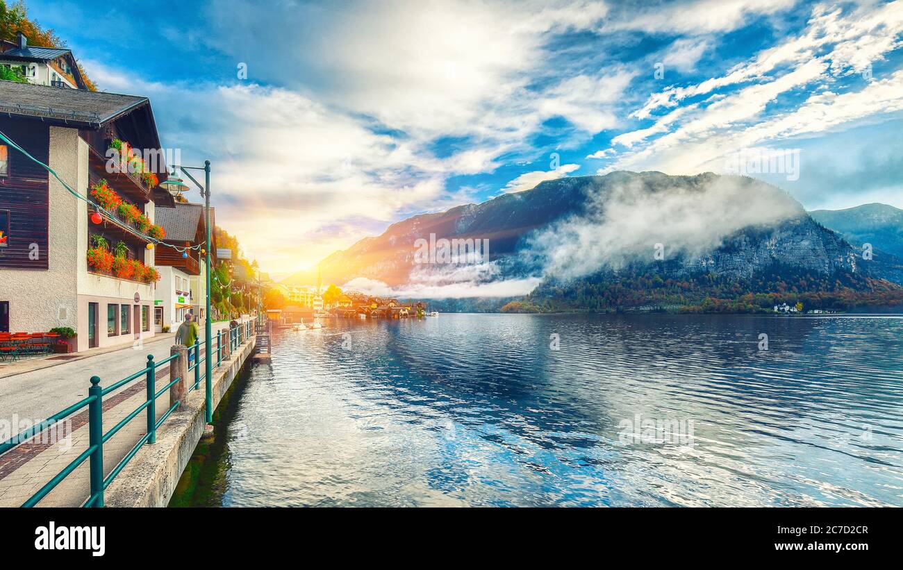 Scenic view of famous Hallstatt mountain village with Hallstatter lake. Foggy autumn sunrise on ...