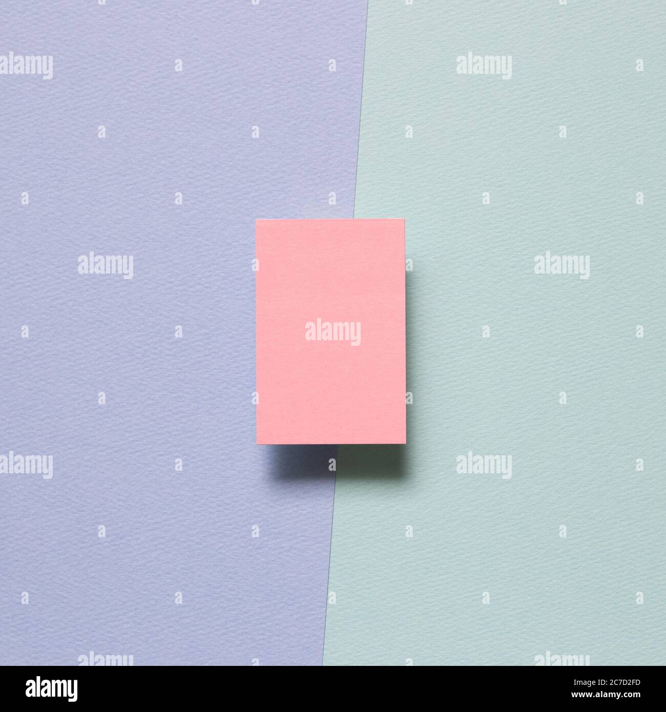 Pink memo paper, sticky notes on purple and green background. top view ...