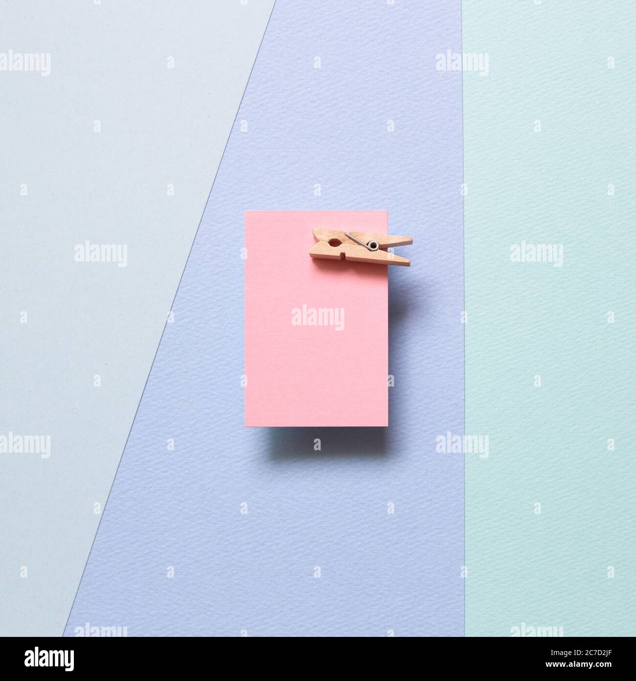 Pink memo paper, sticky notes with wooden clip on blue background. top ...