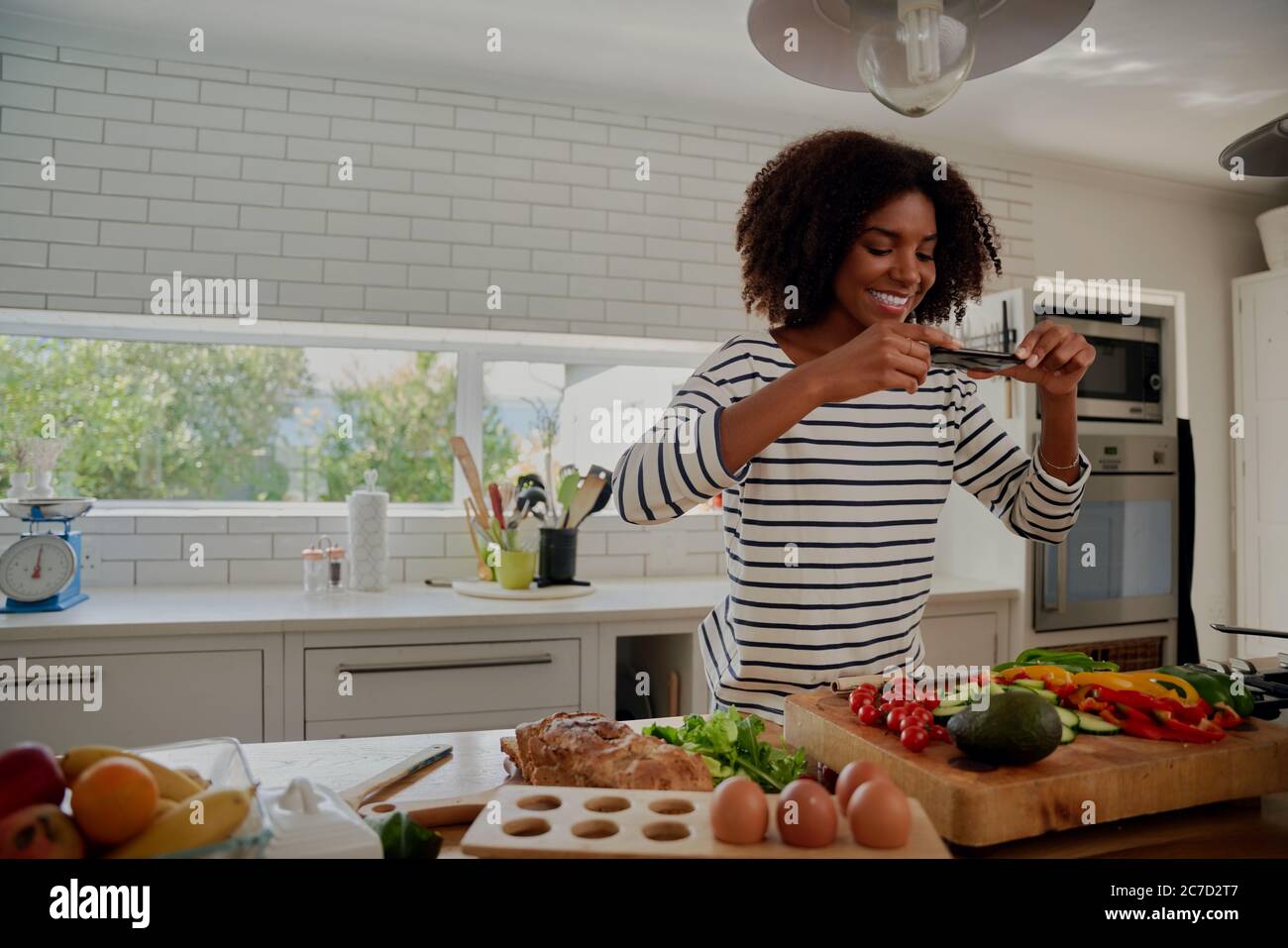 Side video of young successful female food blogger taking picture of ...