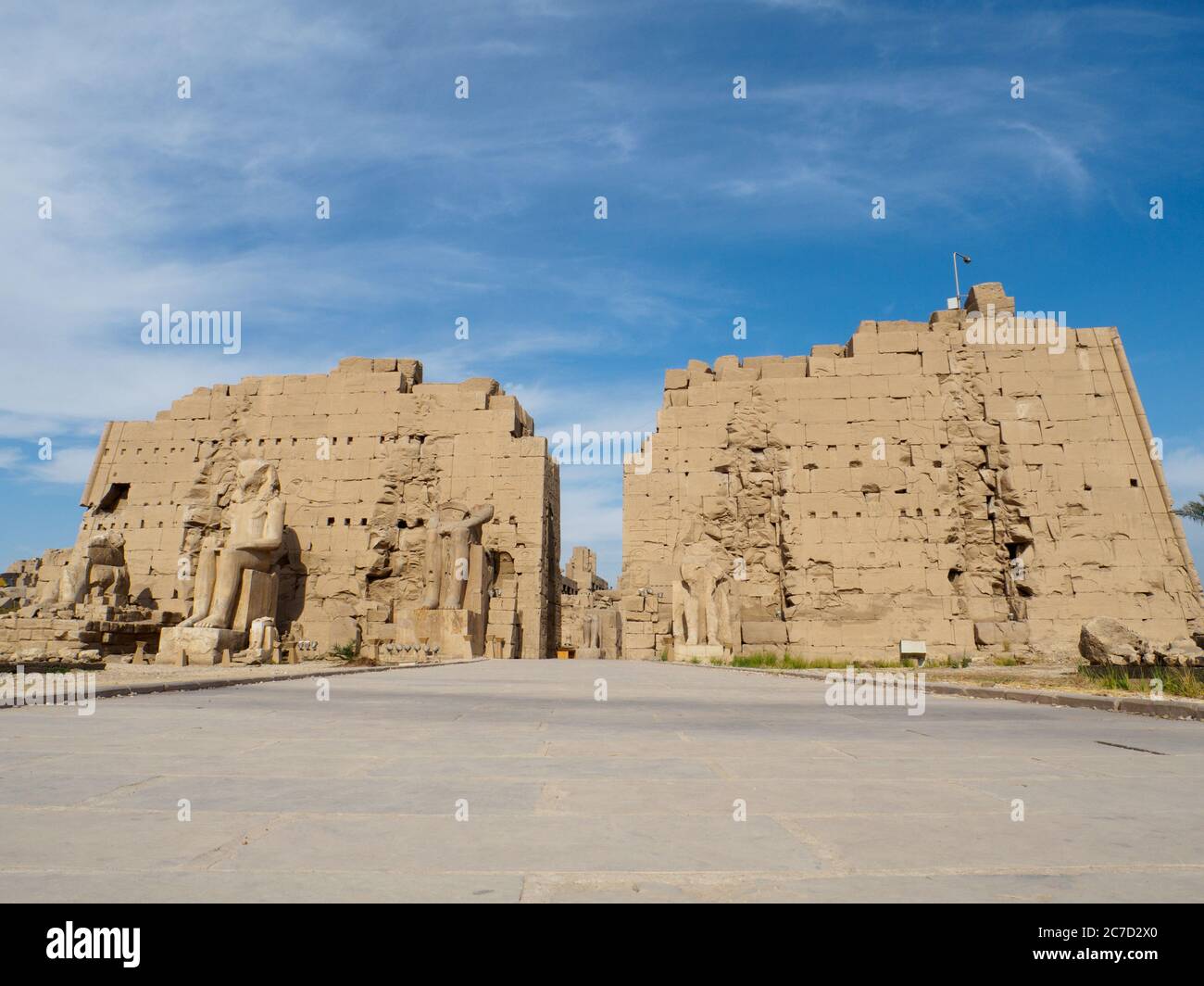 the imposing facade (pylon) of karnak temple with statues and a big ...