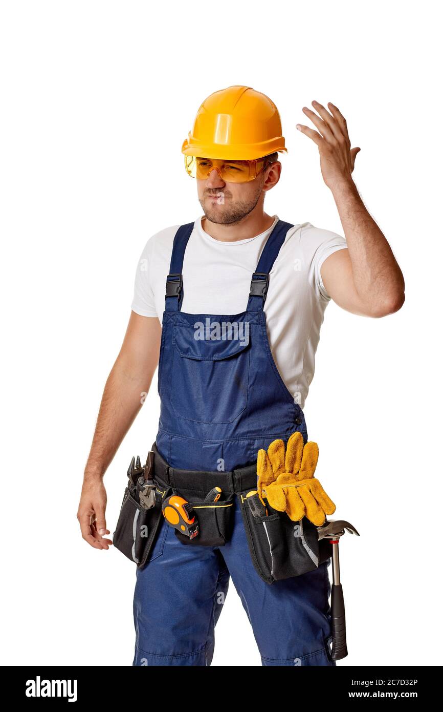 angry caucasian repairman worker in yellow hard hat and uniform ...