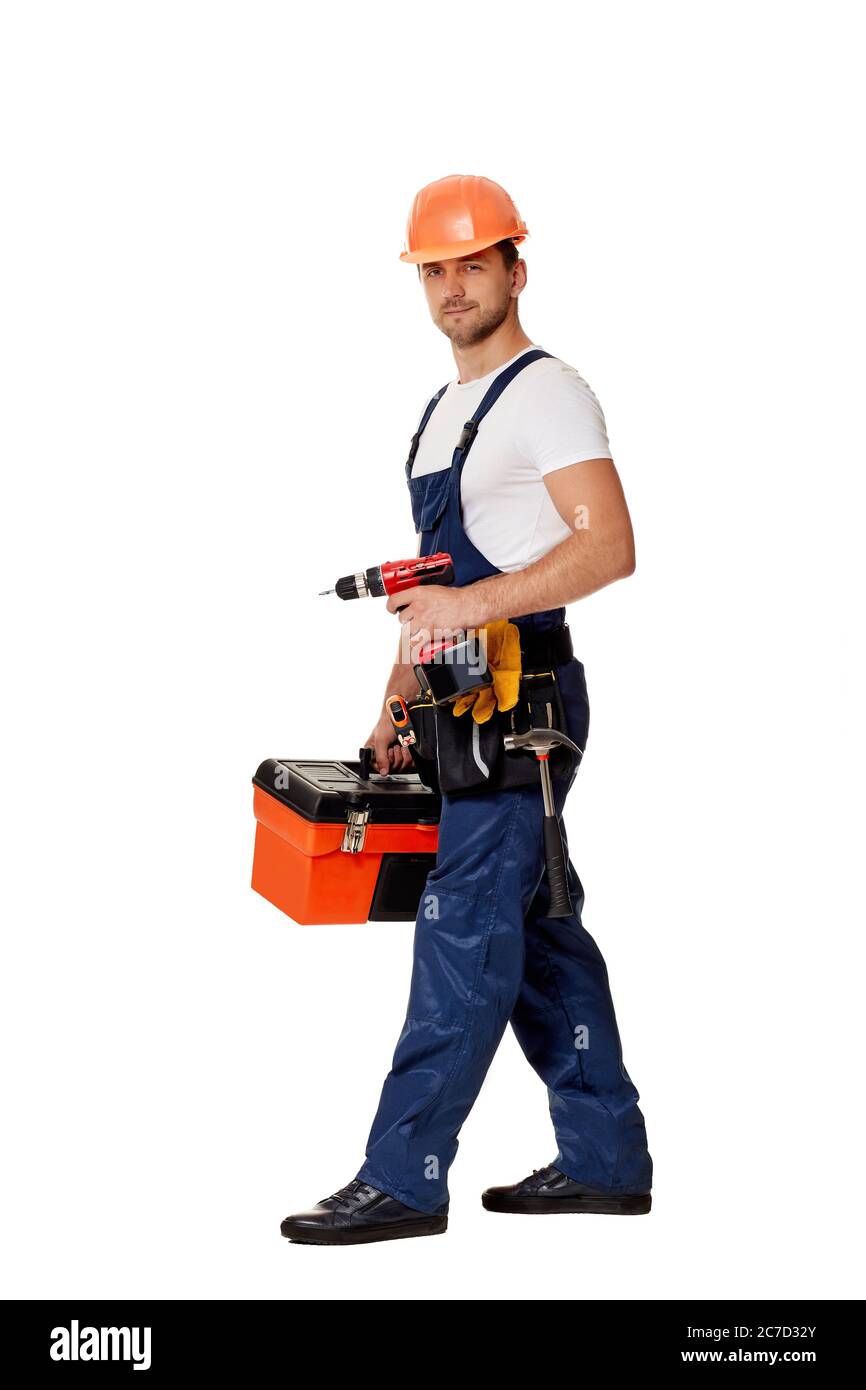 caucasian repairman worker in uniform and helmet holding cordless ...