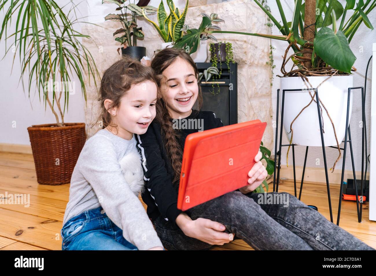 Woman with children sitting at home and holding videocall. Family using ...