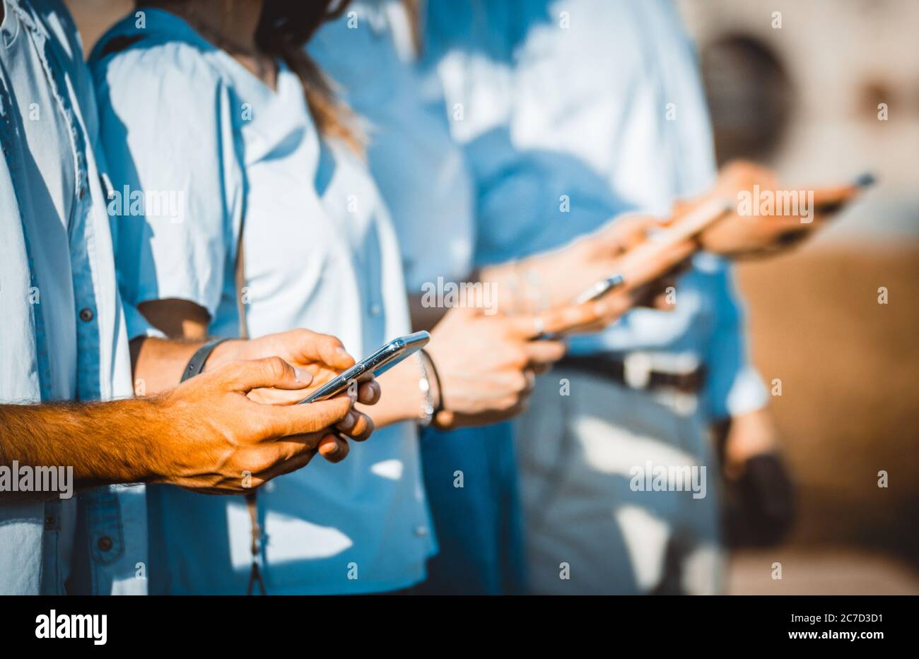 close up photos of group of young friends using smartphone outdoor ...