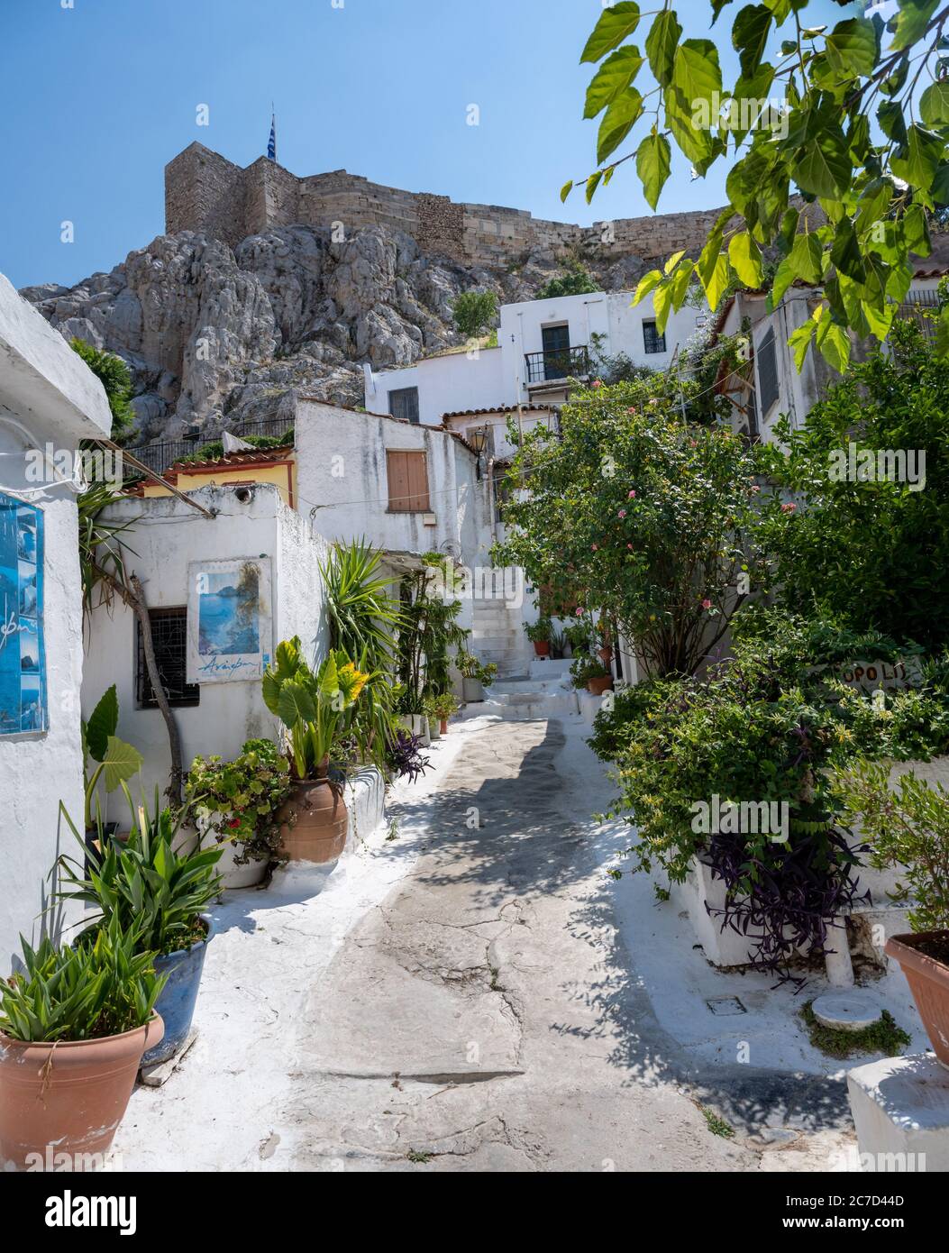 Small narrow alley with white picturesque houses below the Acropolis in ...