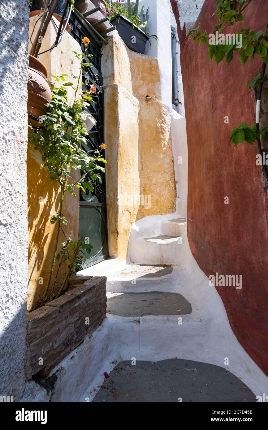 Small narrow alley with white picturesque houses below the Acropolis in ...
