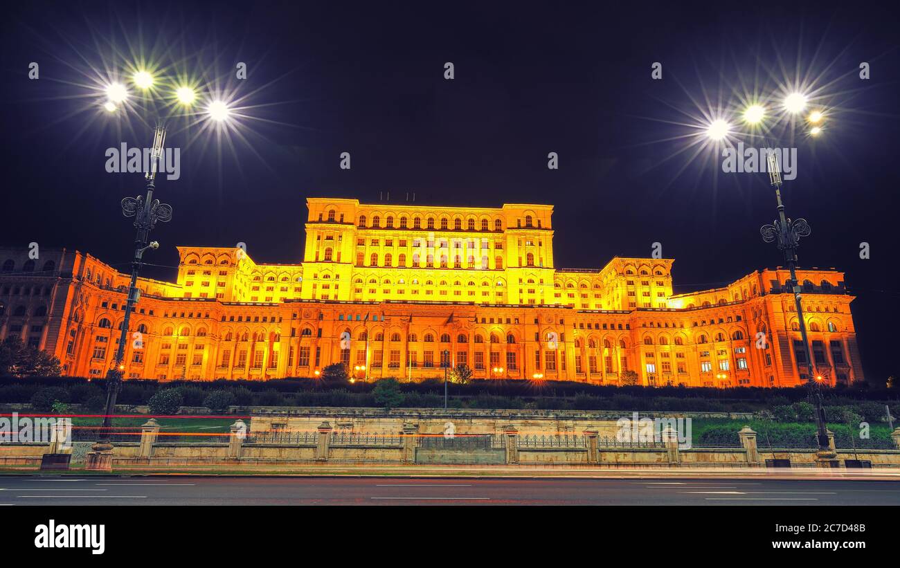 Illuminated Palace of the Parliament of Bucharest at night. Dramatic ...