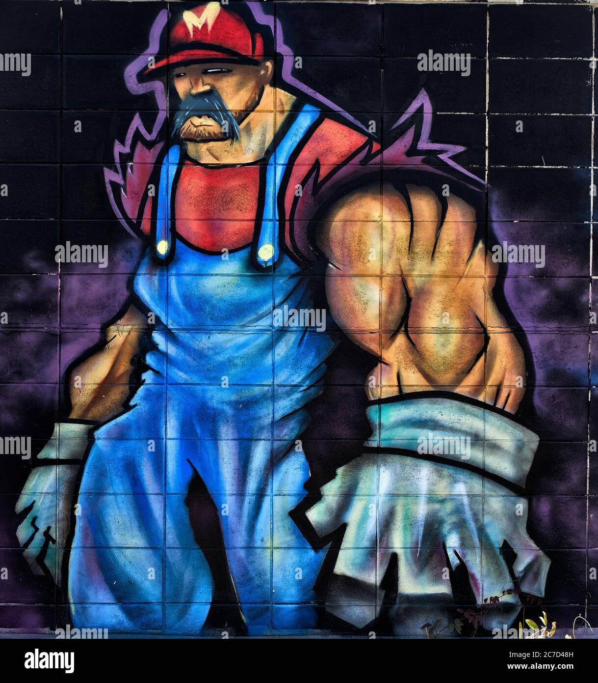 Graffiti. Colourful wall art. Muscular powerful man Stock Photo - Alamy
