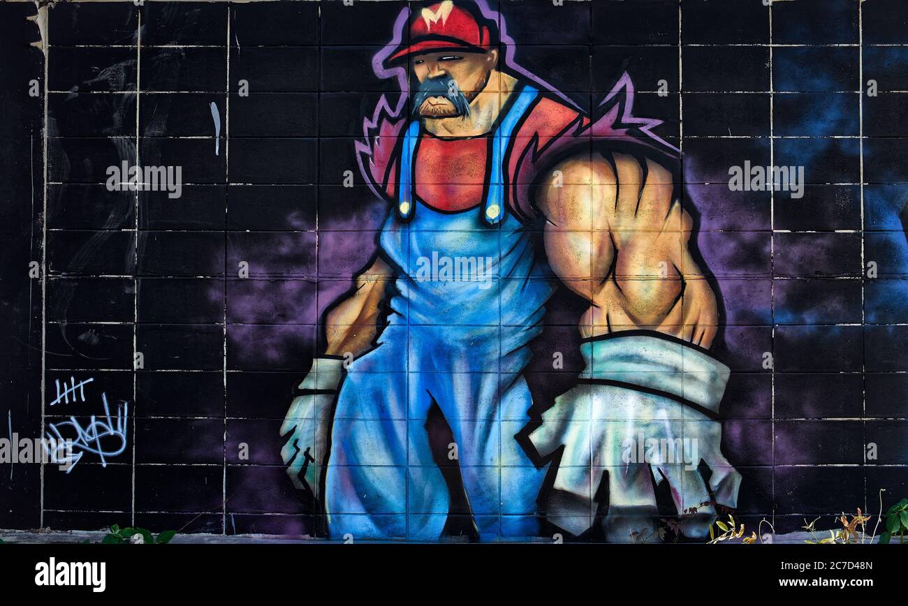 Graffiti. Colourful wall art. Muscular powerful man Stock Photo - Alamy