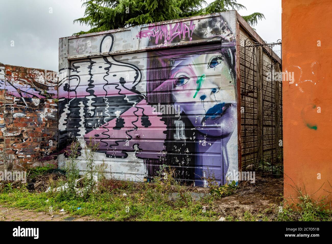 Unkept and dirty back alleyways between residenial properties the back ...