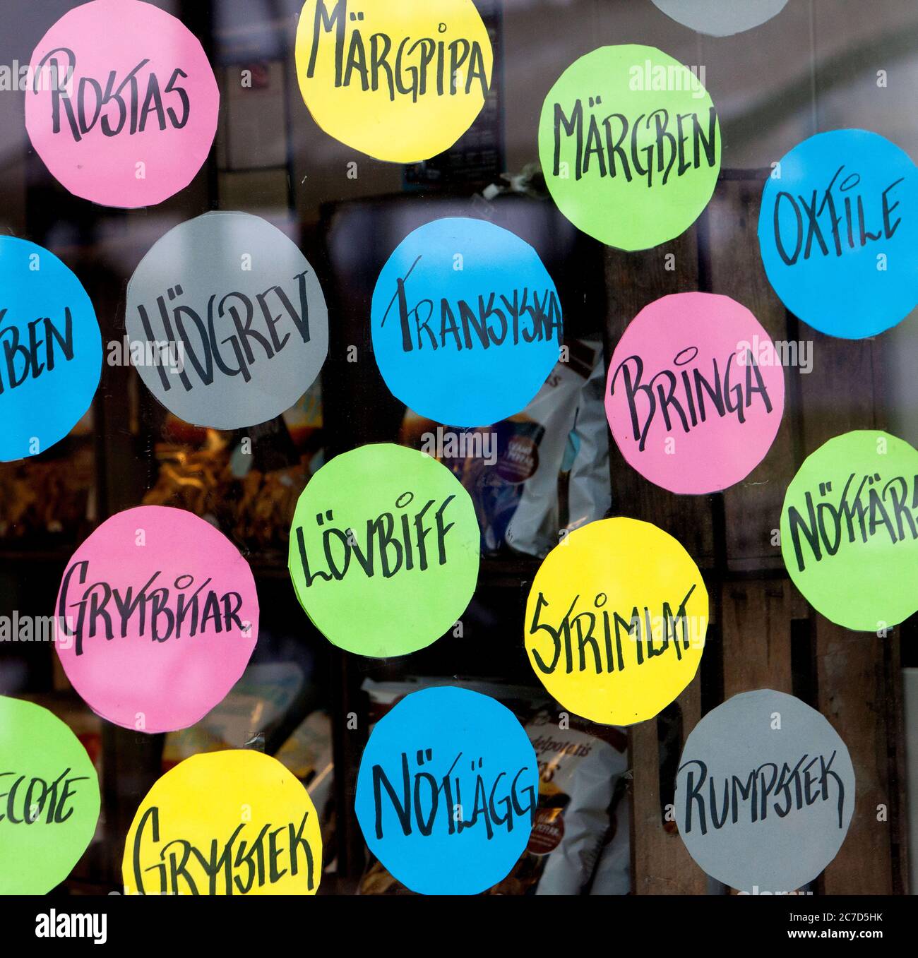 Signs, in a shop window, for different kinds of meat in a meat shop ...