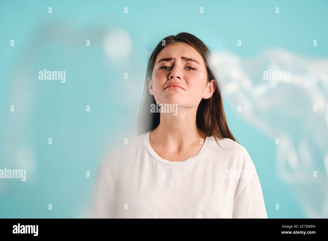 Crying girl with plastic around sadly looking in camera over colorful ...