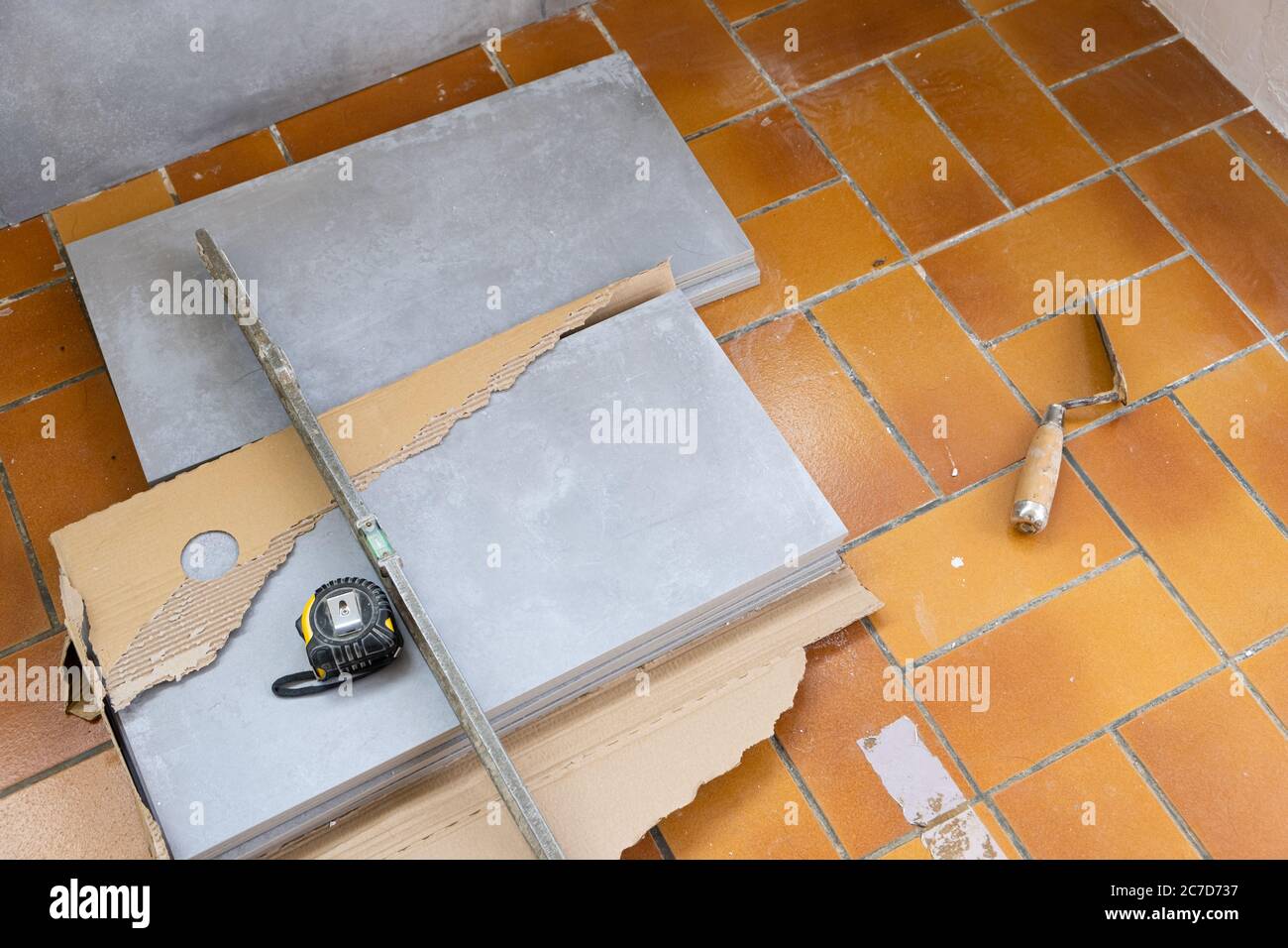 ceramic tile installation site with its tools Stock Photo - Alamy