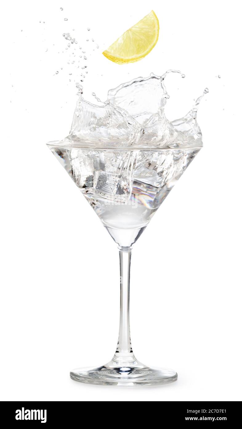 lemon slice falling into a martini cocktail splashing on white ...