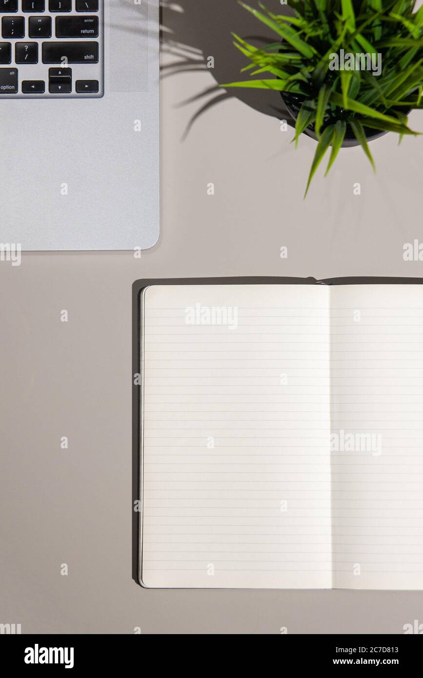 Light office desk table with laptop and supplies with blank notebook ...