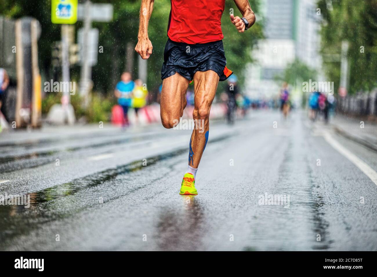 perfect legs runner athlete man run in rainy weather marathon Stock ...