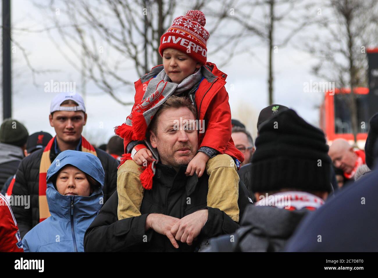 A young Liverpool fan rides his dad’s shoulders outside Anfield Stock ...