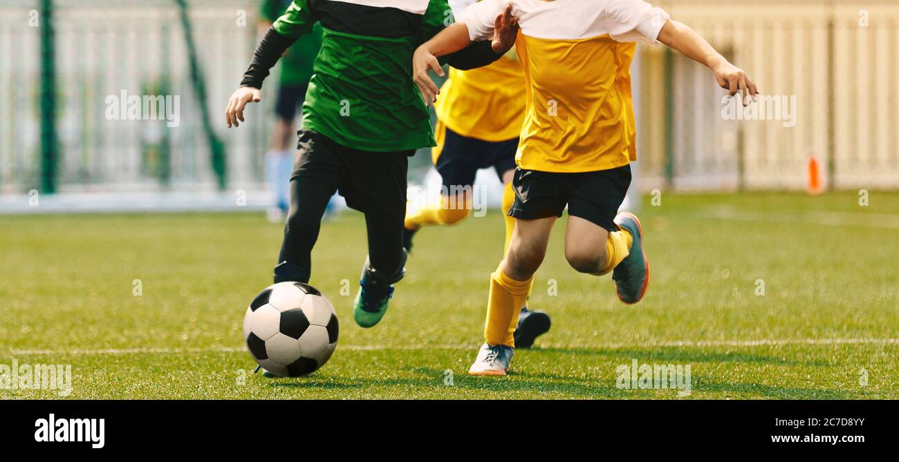 Junior Football Match. Boys Kicking Soccer Match on Grass Sports Field ...