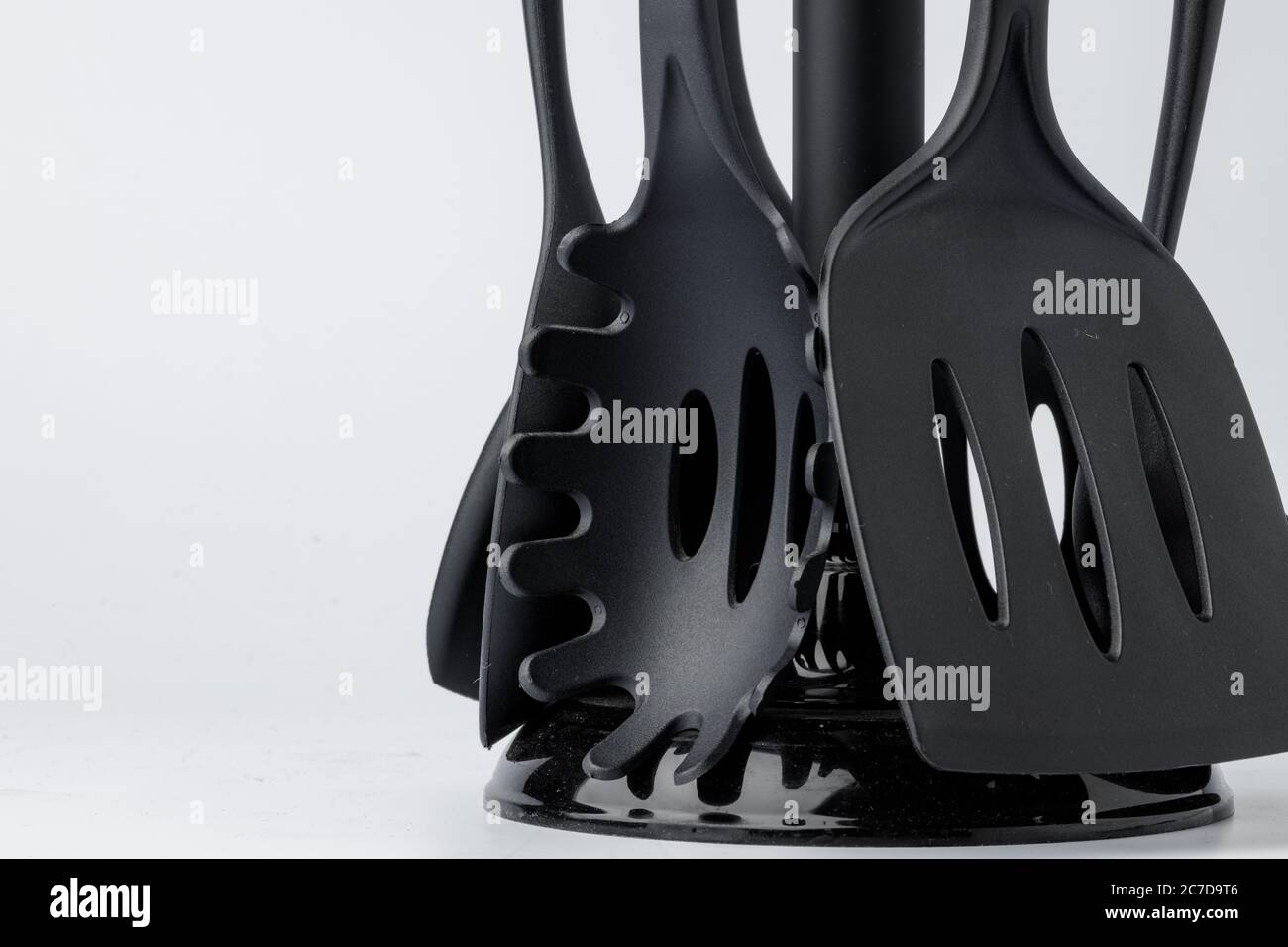 Stand with set of kitchen utensils on white background Stock Photo - Alamy