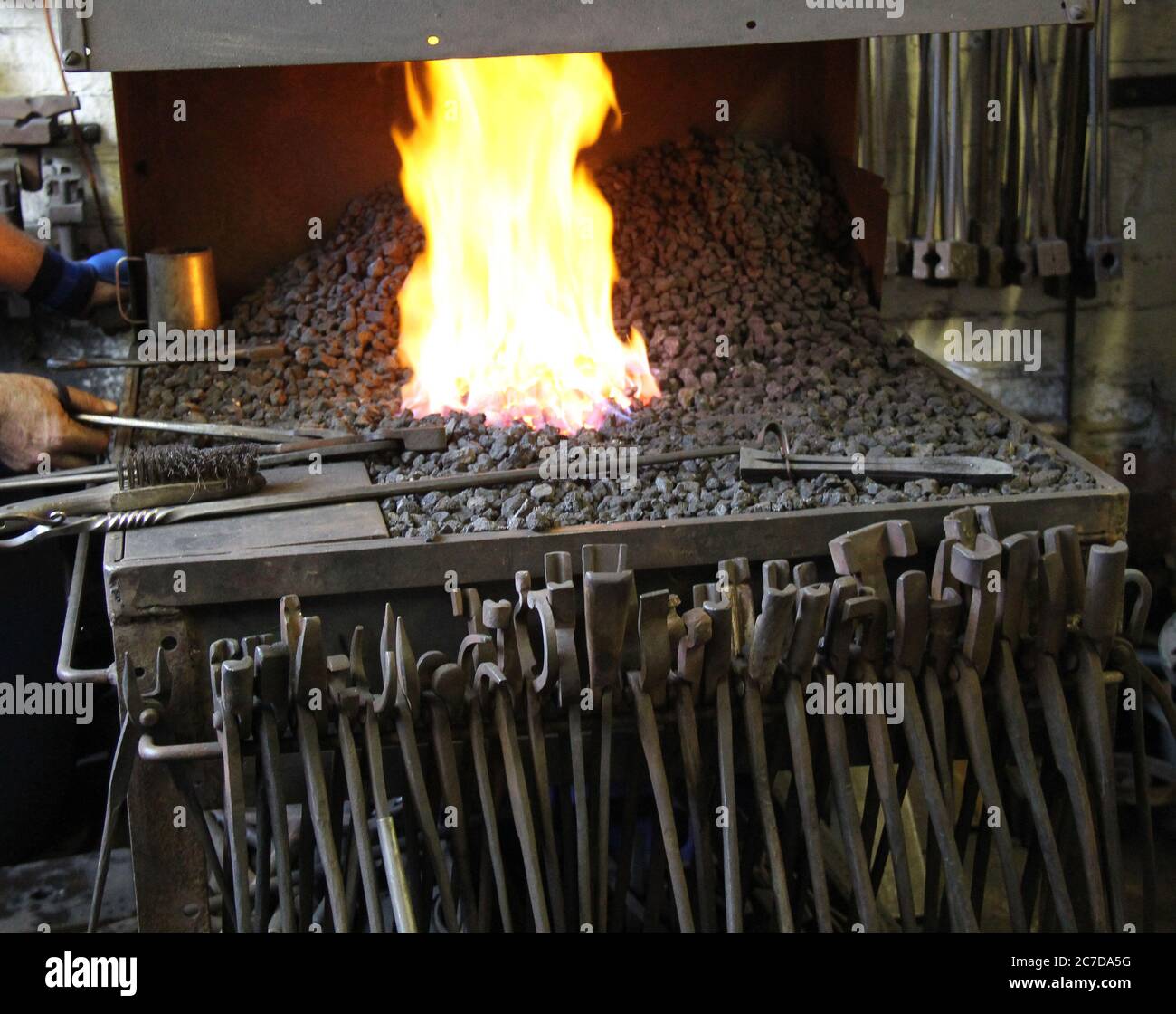 The Roaring Coal Fire and Tools at a Blacksmith Forge Stock Photo - Alamy