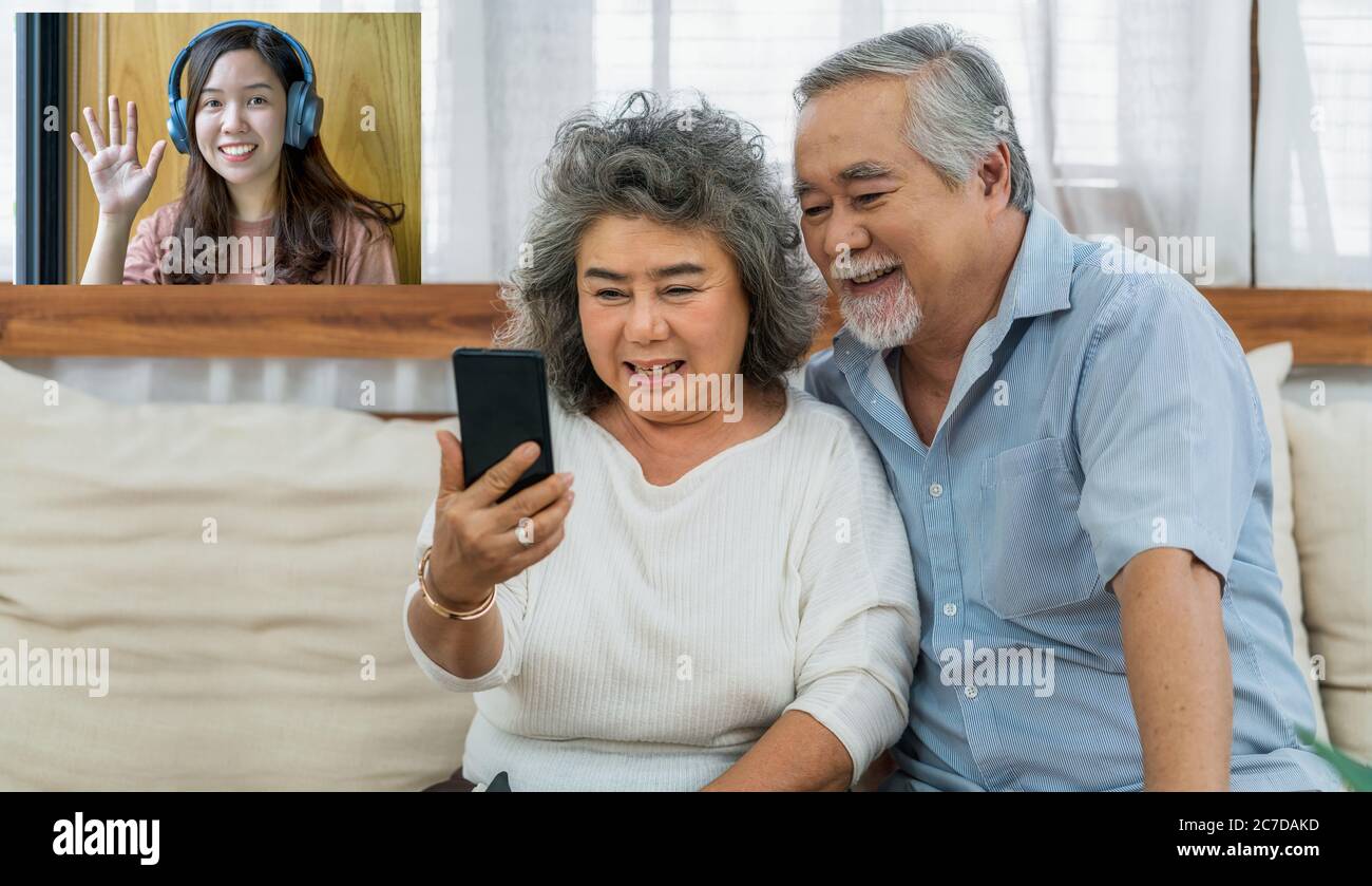 Asian couple Grandparent taking Video call to grandchild woman with ...