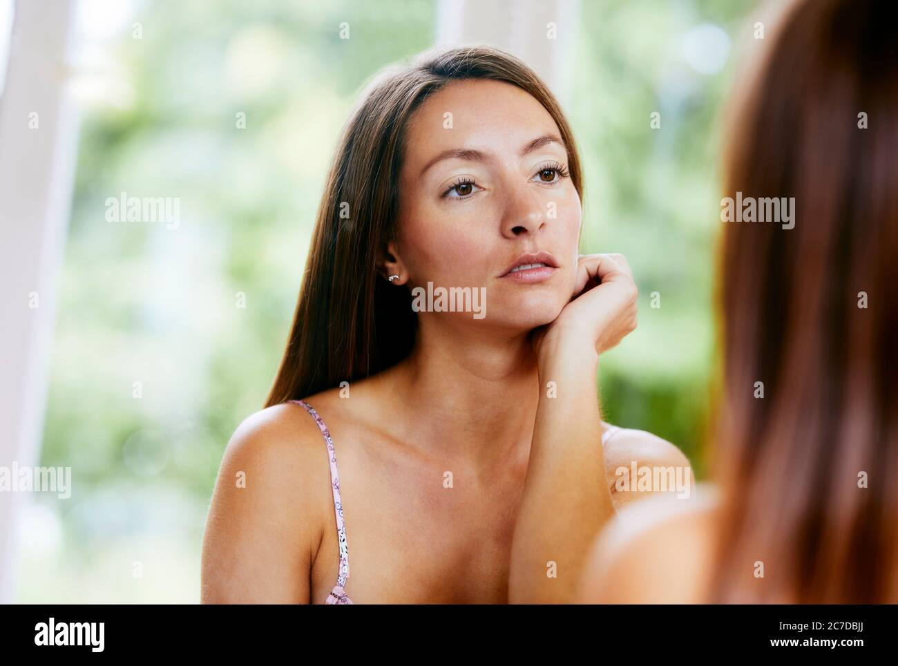 Girl looking thoughtful Stock Photo - Alamy
