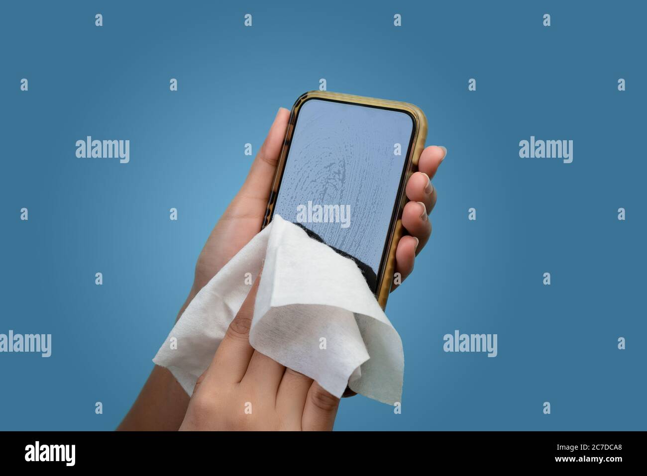 Female hands cleaning screen of mobile phone device with antibacterial ...