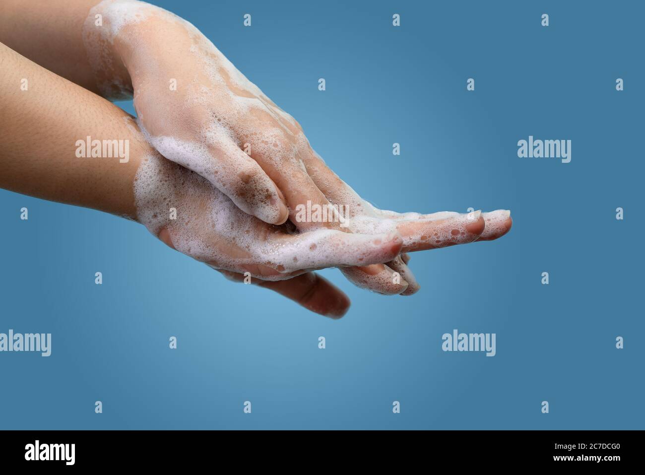 Side view of female washing hands with soap and water with interlaced ...