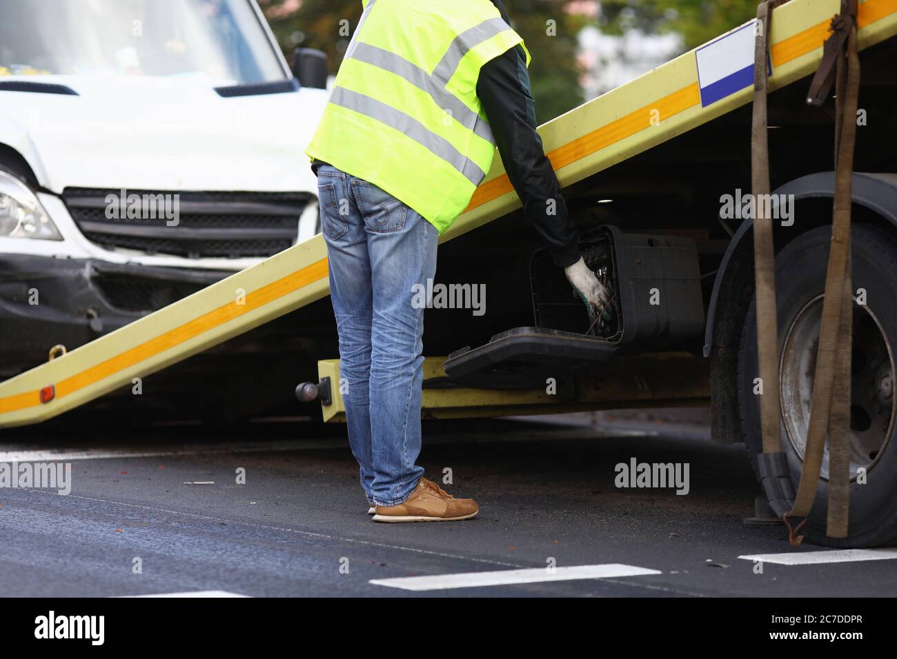 Crashed car loaded on tow truck closeup Stock Photo - Alamy