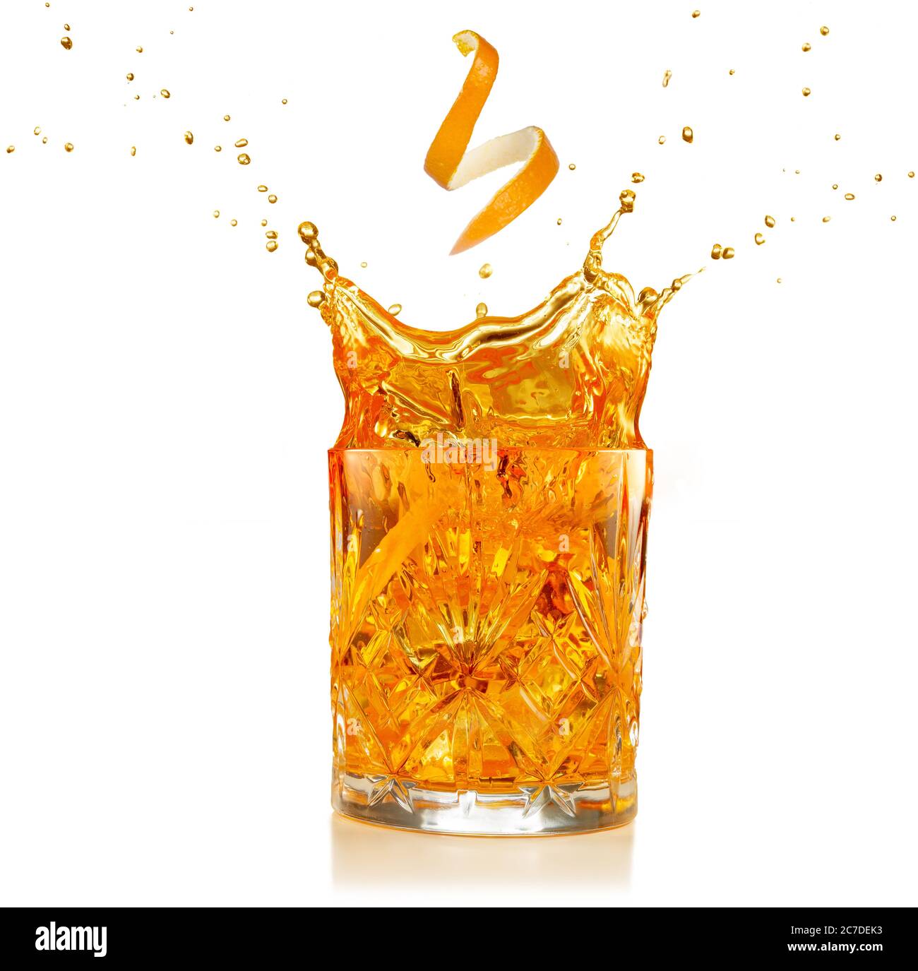 orange zest falling into a splashing cocktail isolated on white Stock ...