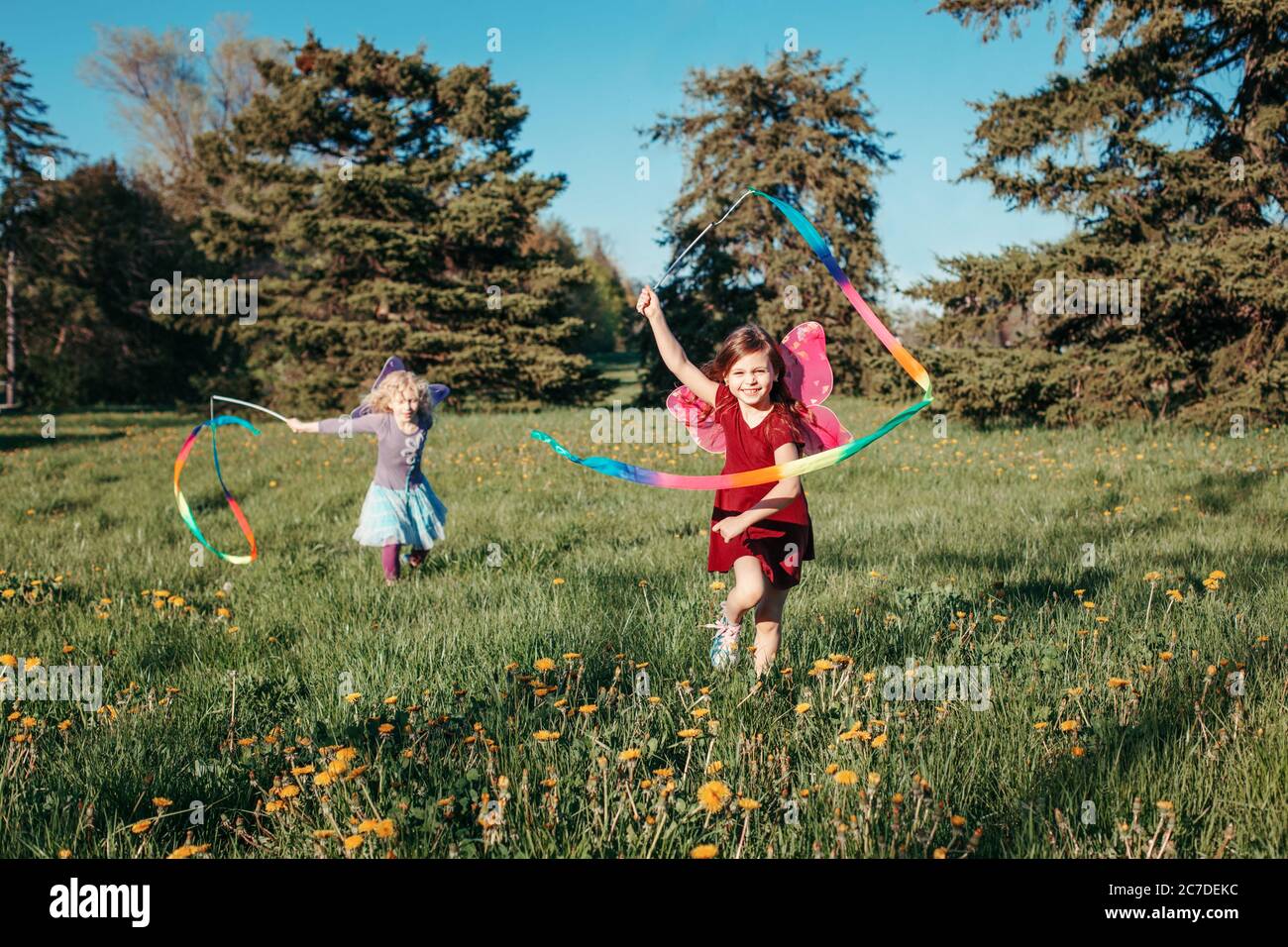 Happy children girls playing with ribbons in park. Cute adorable kids ...