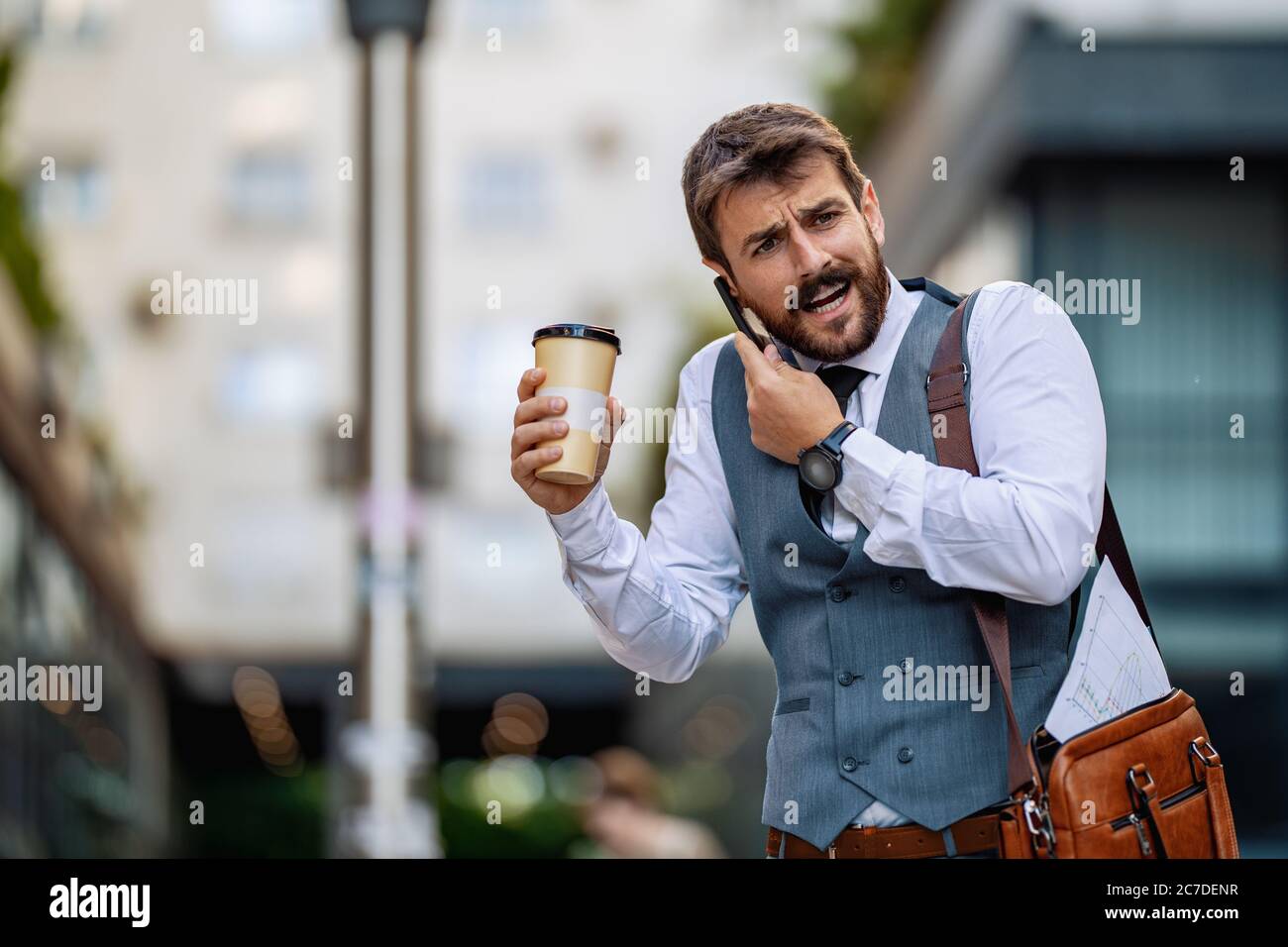 Attractive young businessman using a smart phone.Portrait of handsome ...