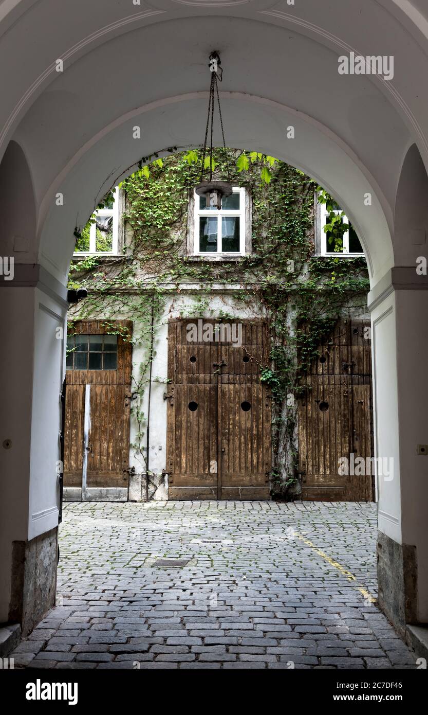 Courtyard Of A HIstoric Building With Wooden Doors And Ivy Overgrown ...