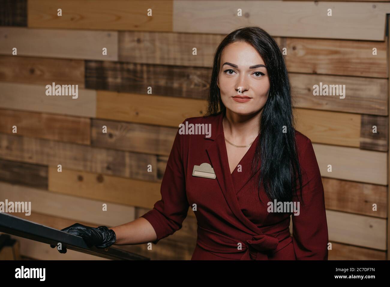 A close photo of a gorgeous female restaurant manager in black ...