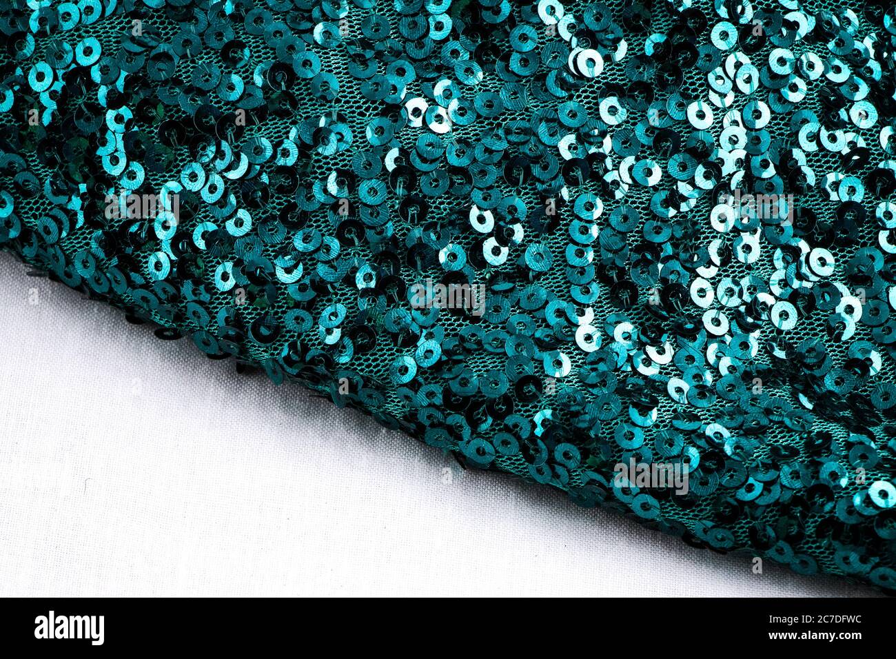 Turquoise shimmer sequined textured fabric diagonal on white Stock ...