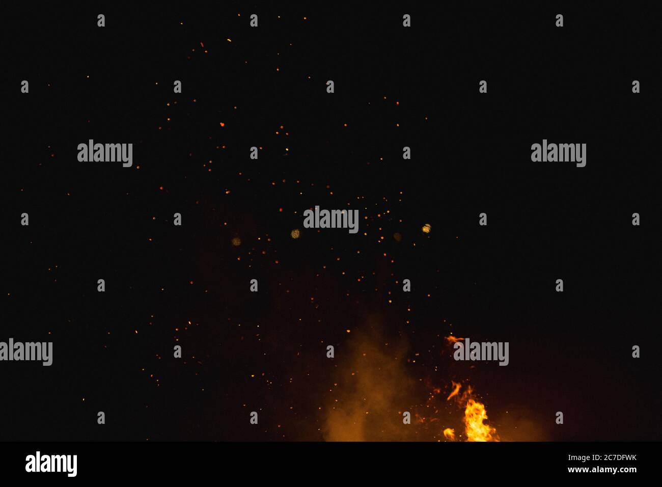 Low angle shot of fire flames with the background of the dark sky ...