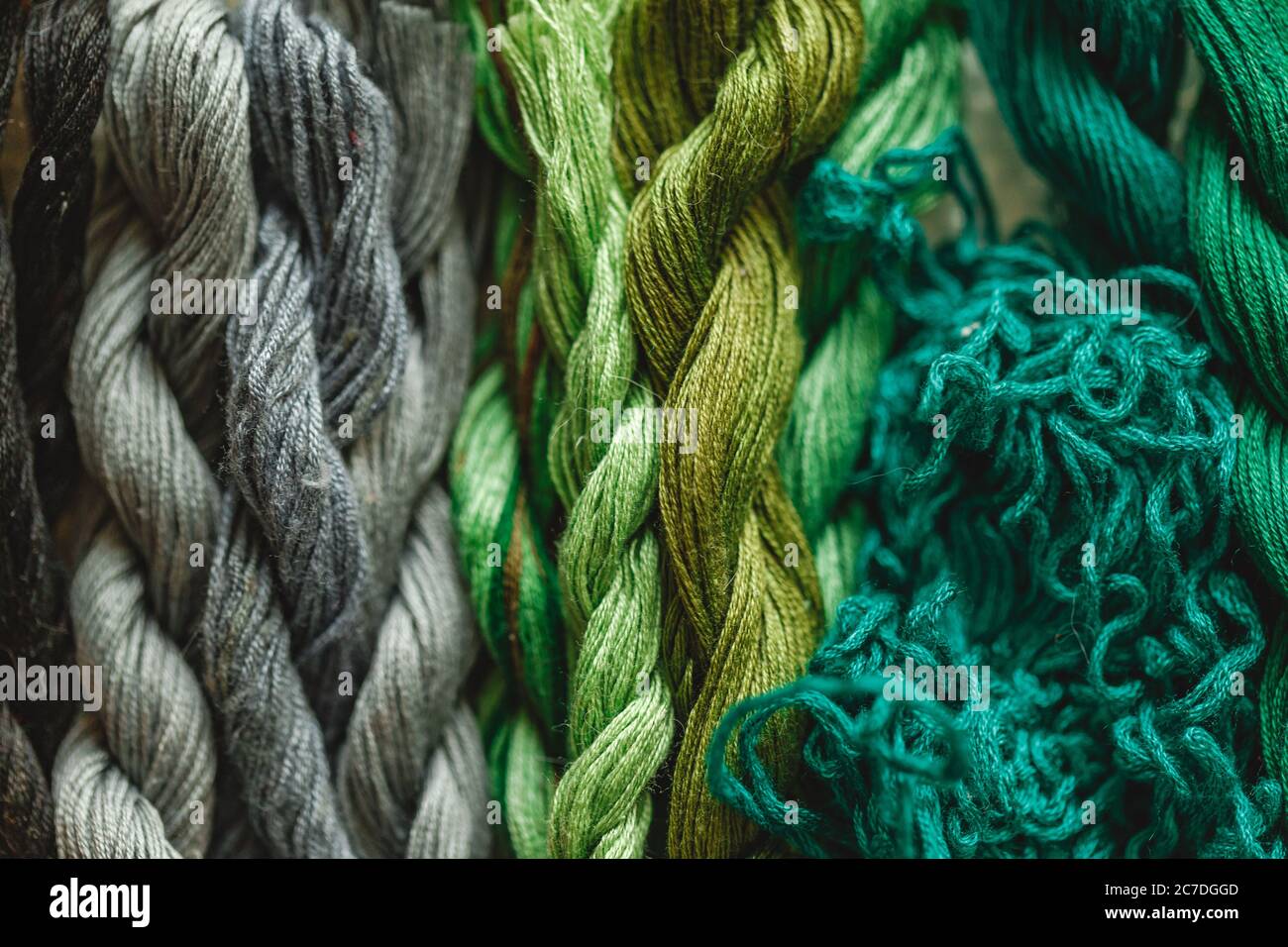 Colorful background from embroidery threads in gray and green colors ...