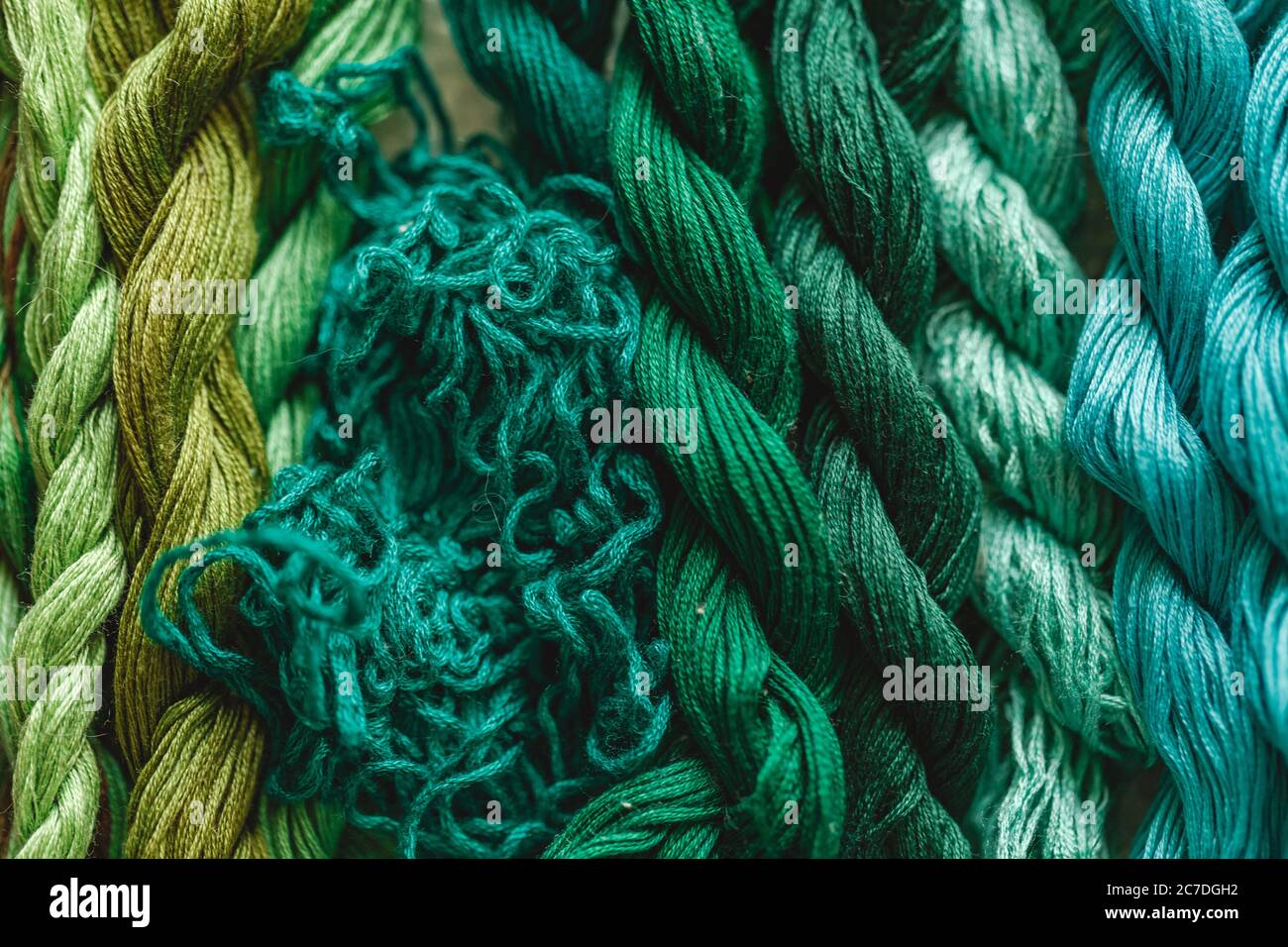 Colorful background from embroidery threads in green colors. Close-up ...