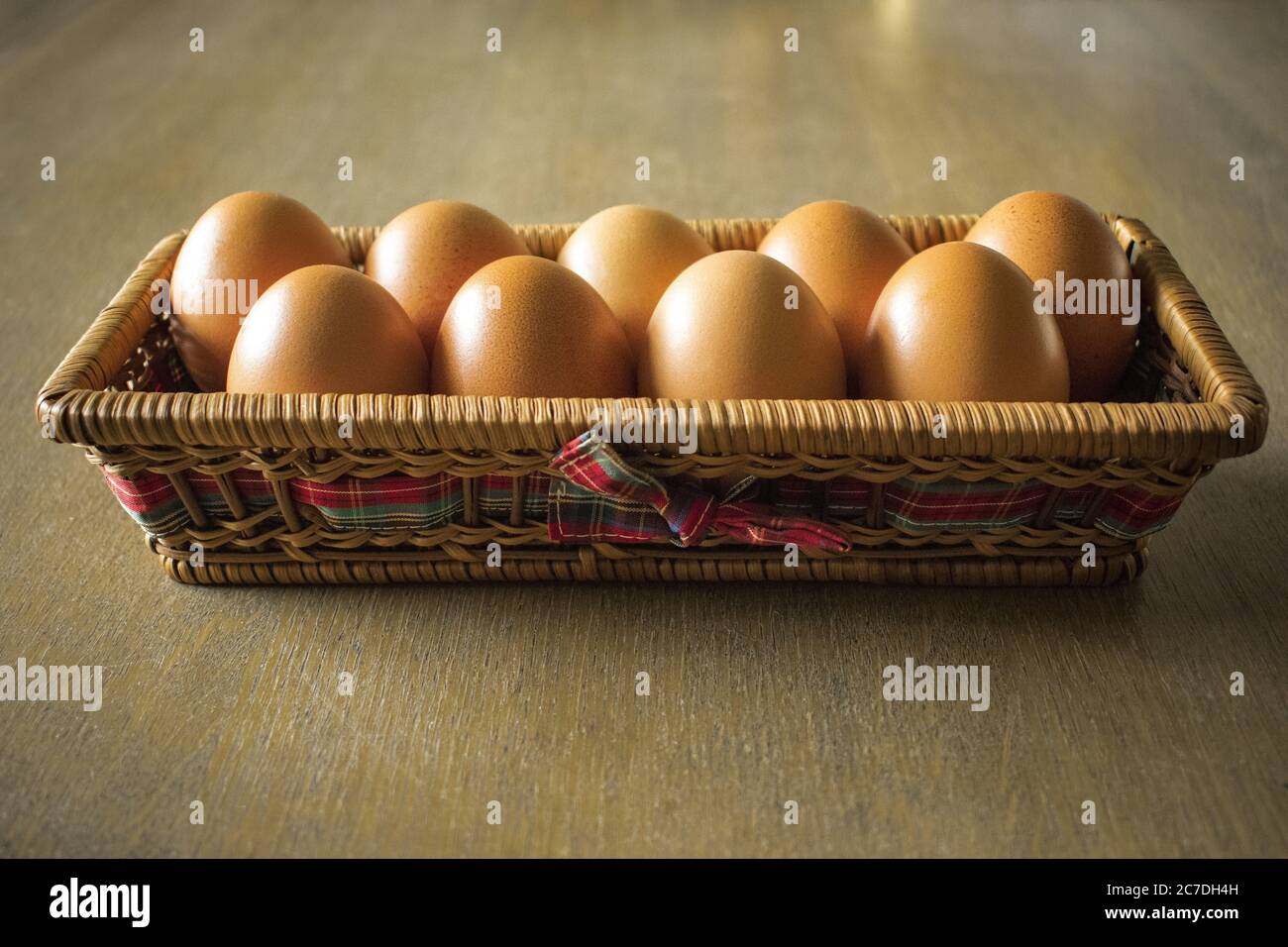 Rectangle basket filled with eggs on a wooden surface Stock Photo - Alamy