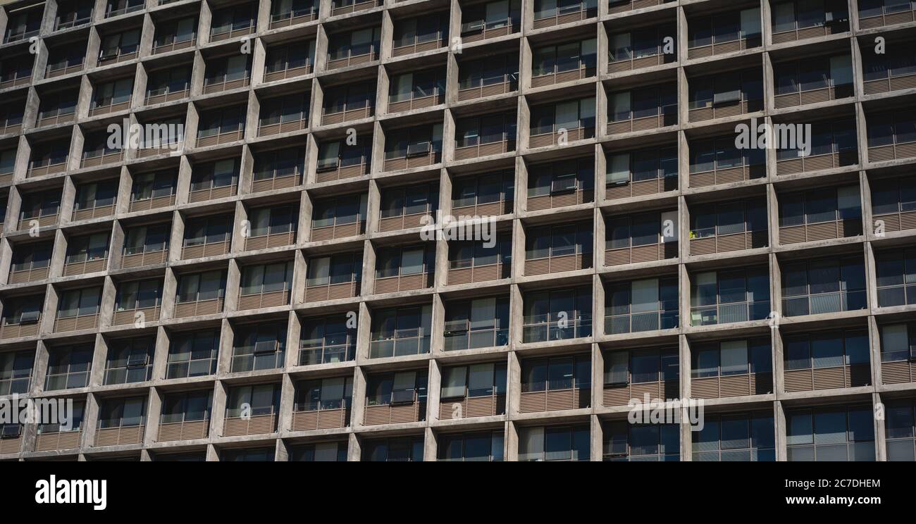 Horizontal shot of a concrete building's side with identical square ...