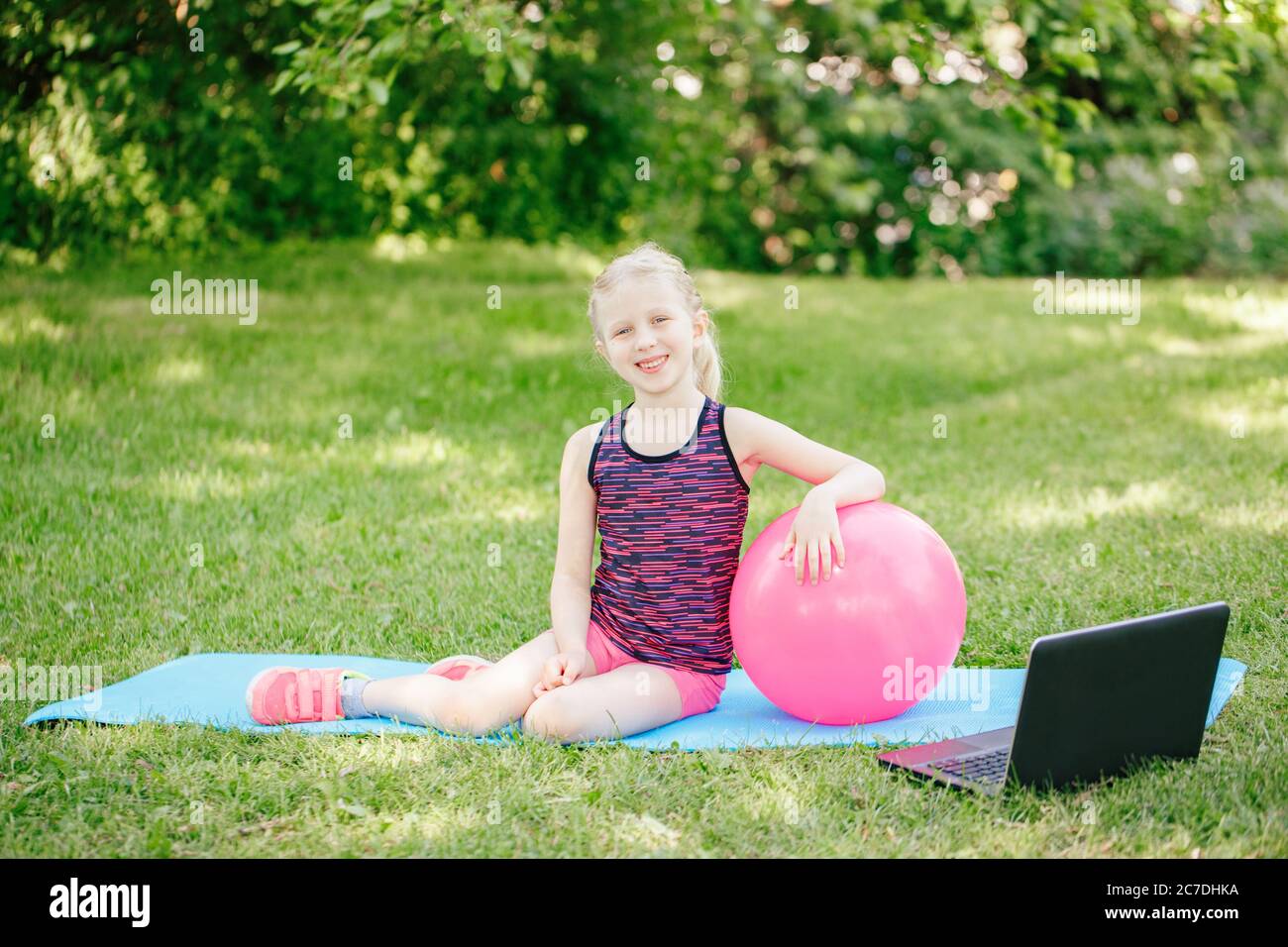 Caucasian smiling girl child doing sport workout outdoor online. Video ...