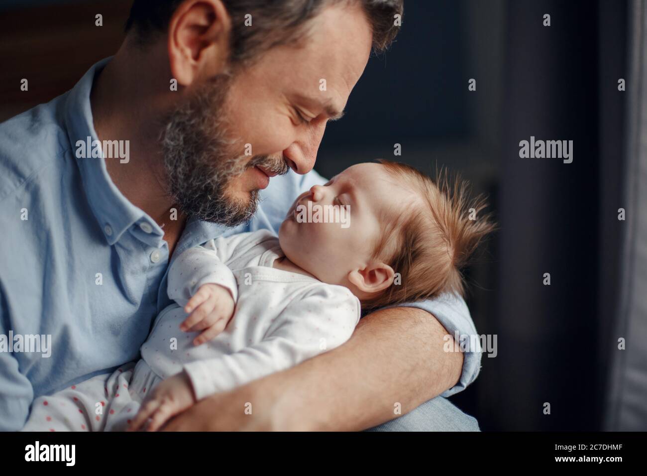 Closeup portrait of middle age bearded Caucasian father hugging and ...