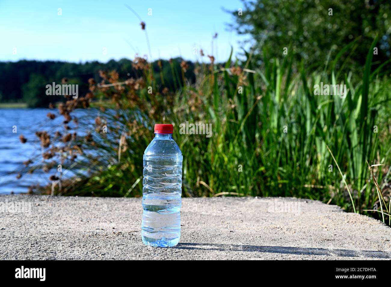 Bottle of water in front of a lake Stock Photo - Alamy